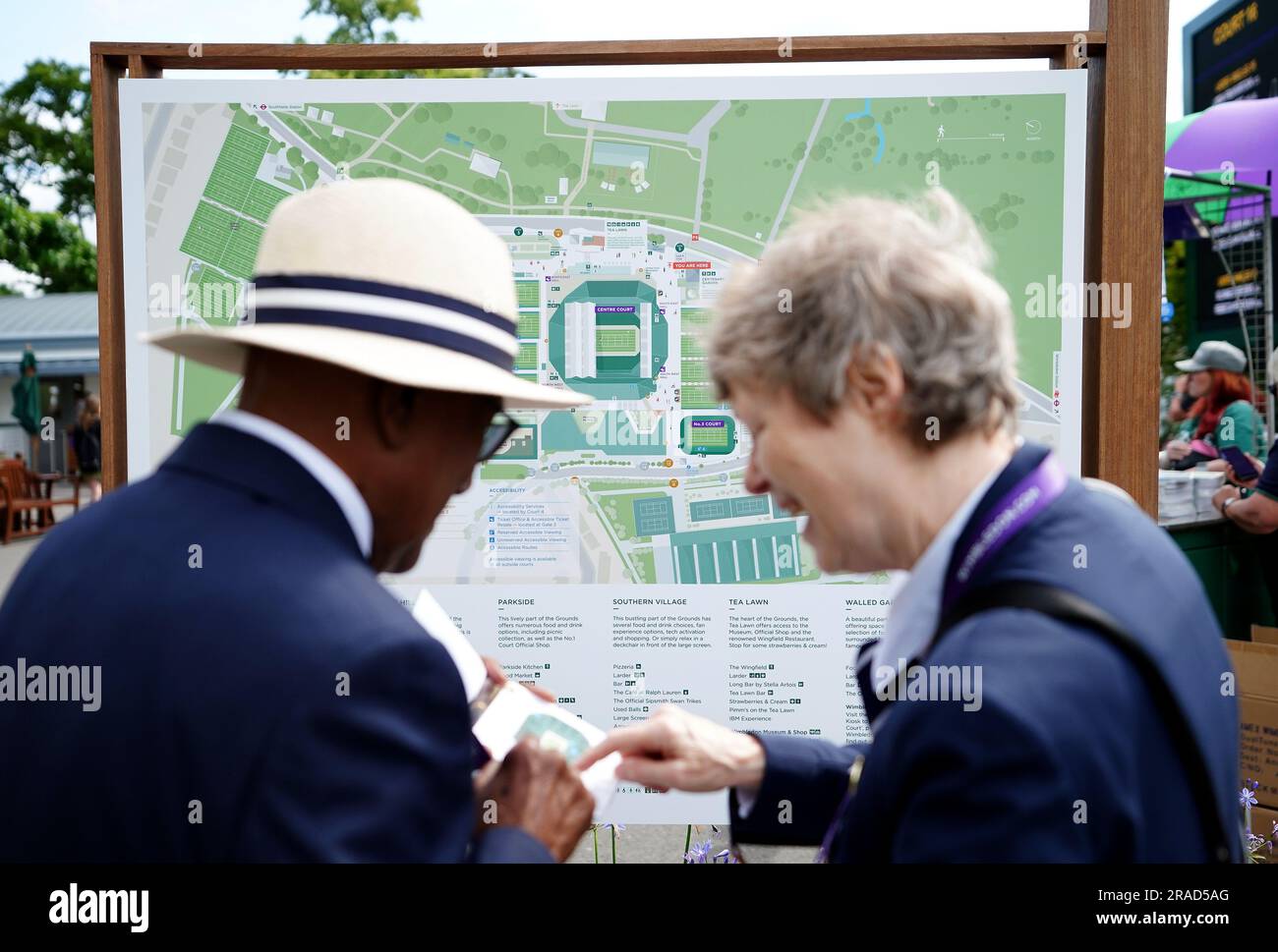 People look at a map of the grounds on day one of the 2023 Wimbledon ...