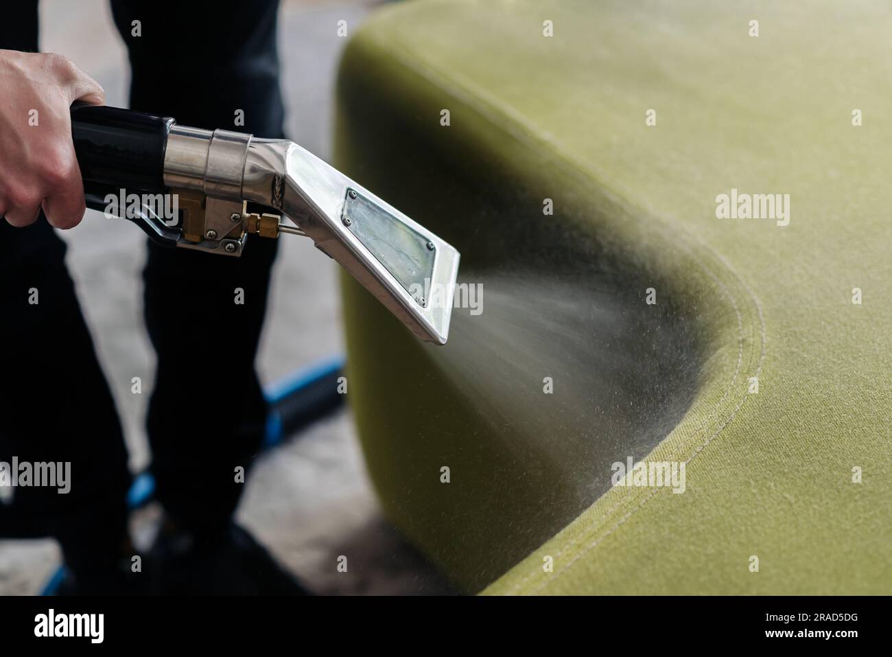 Close-up of housekeeper holding modern washing vacuum cleaner and ...