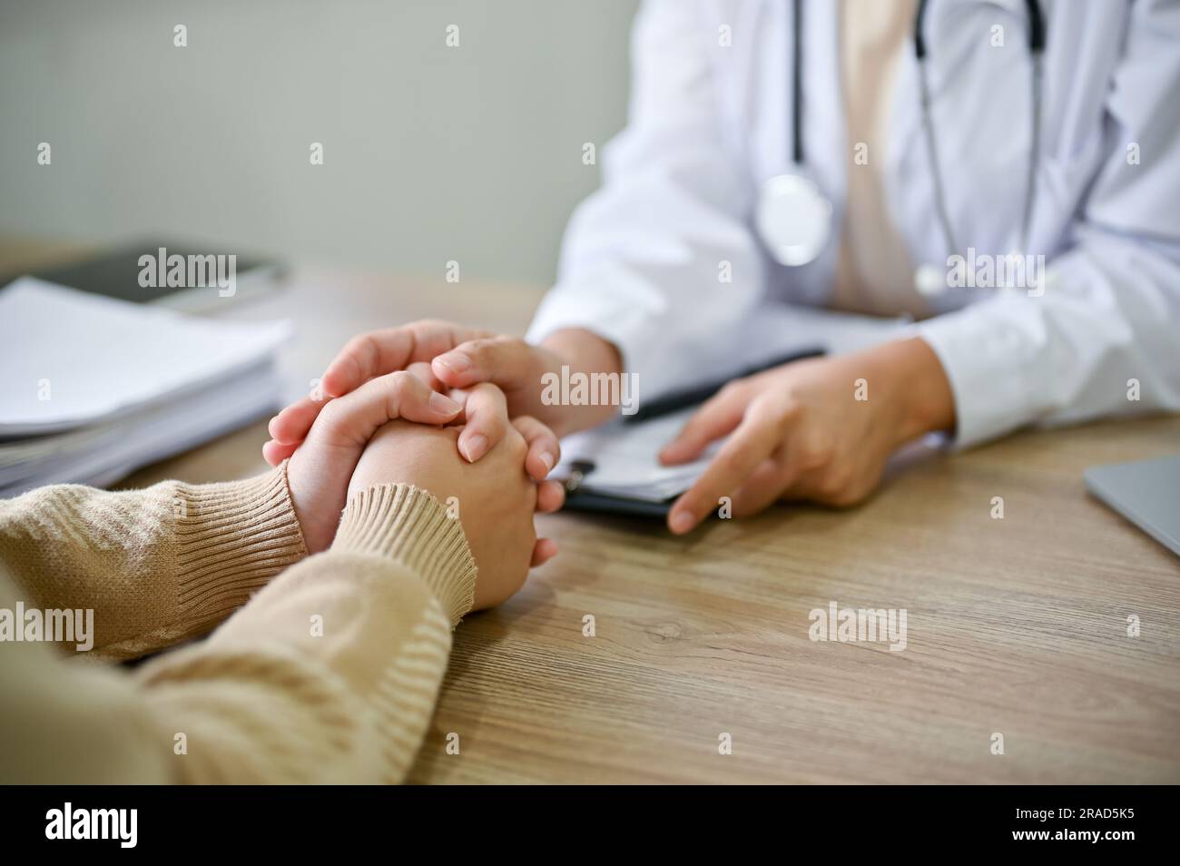 Close up view of doctor touching patient hand, showing empty and ...