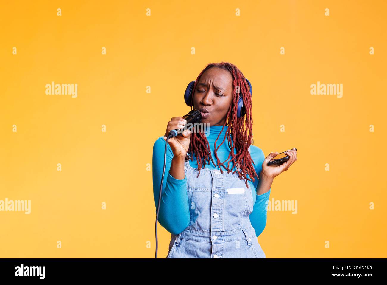 Confident girl having fun with karaoke, vocalist singing songs on ...