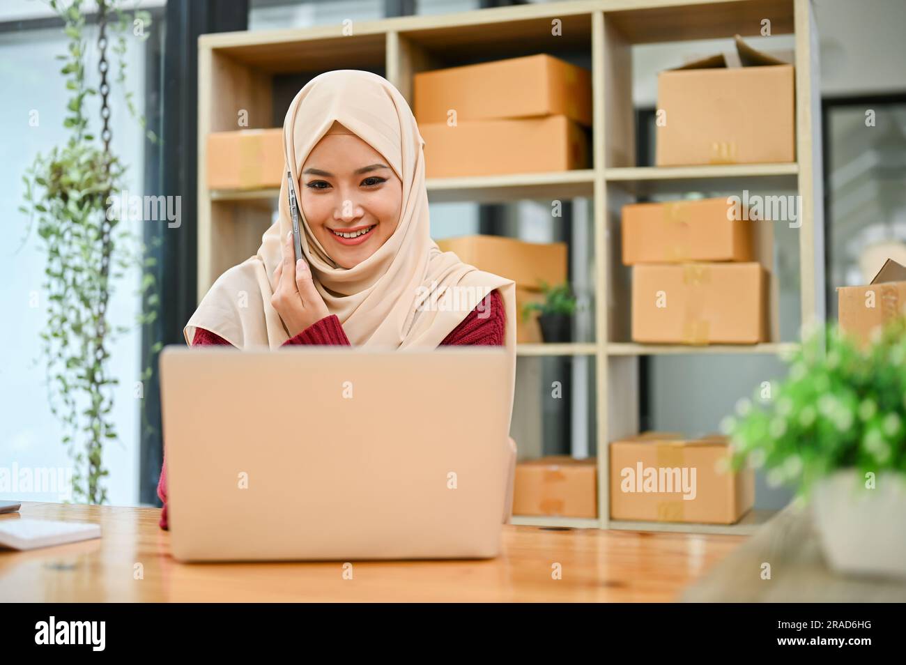 Young beautiful SME online business owner using smartphone to connect ...