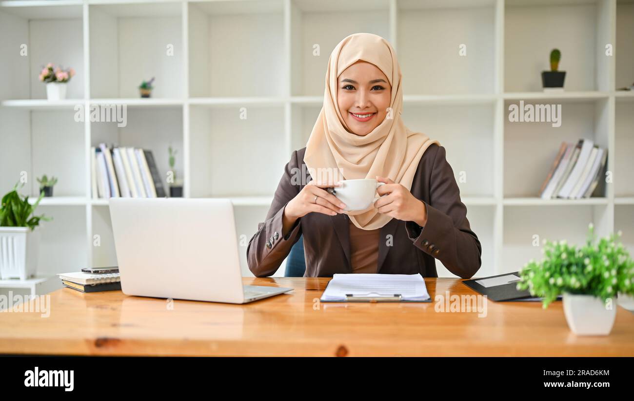 A portrait of a beautiful and successful Asian Muslim businesswoman or ...