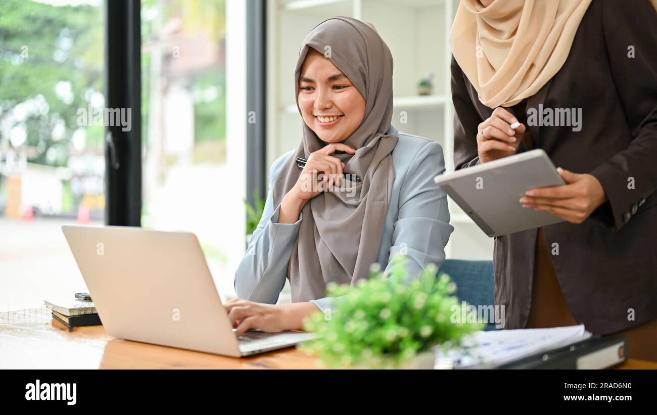 Professional Muslim business team working together, discussing on an ...
