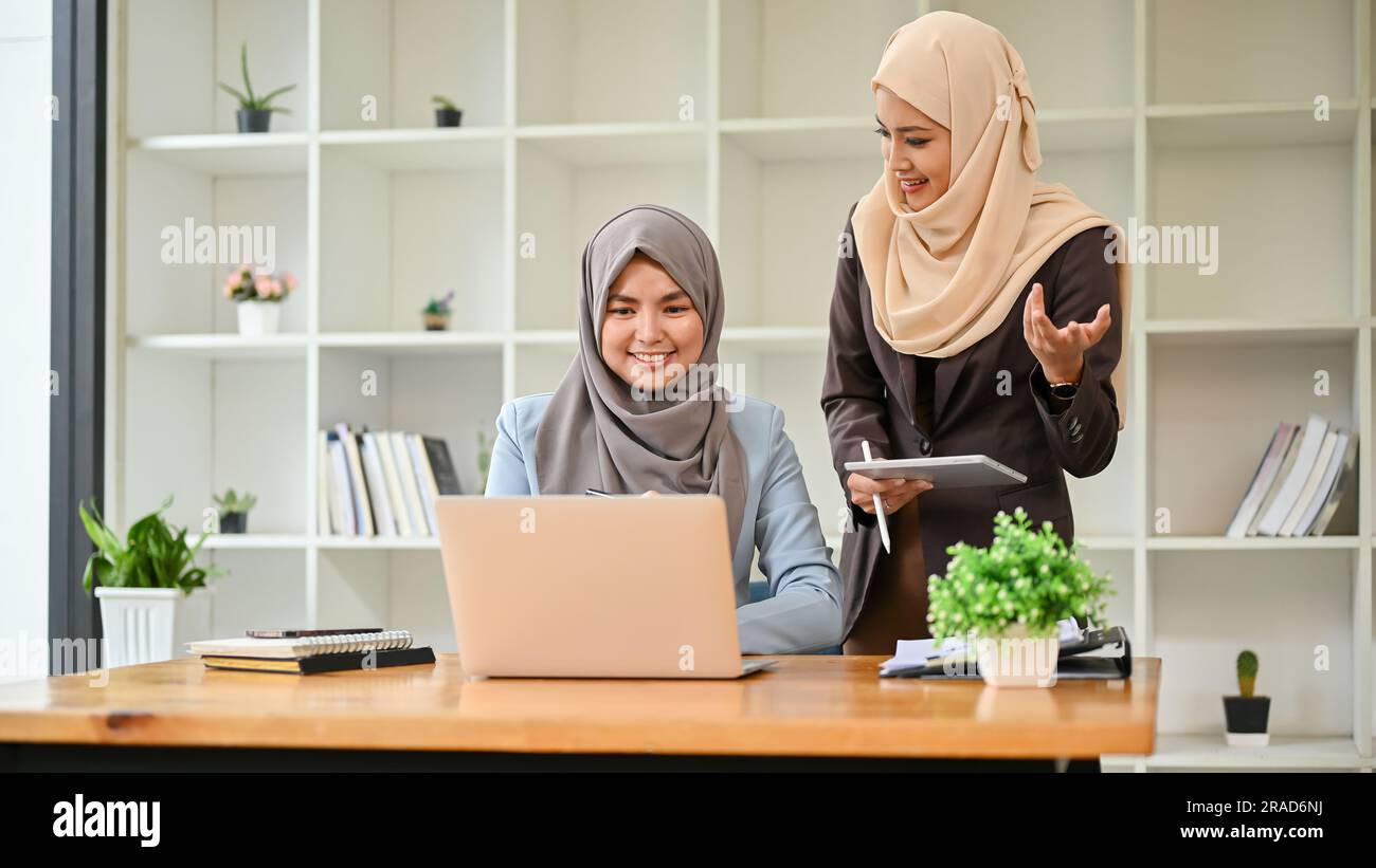 Professional Muslim business team working together, discussing on an ...