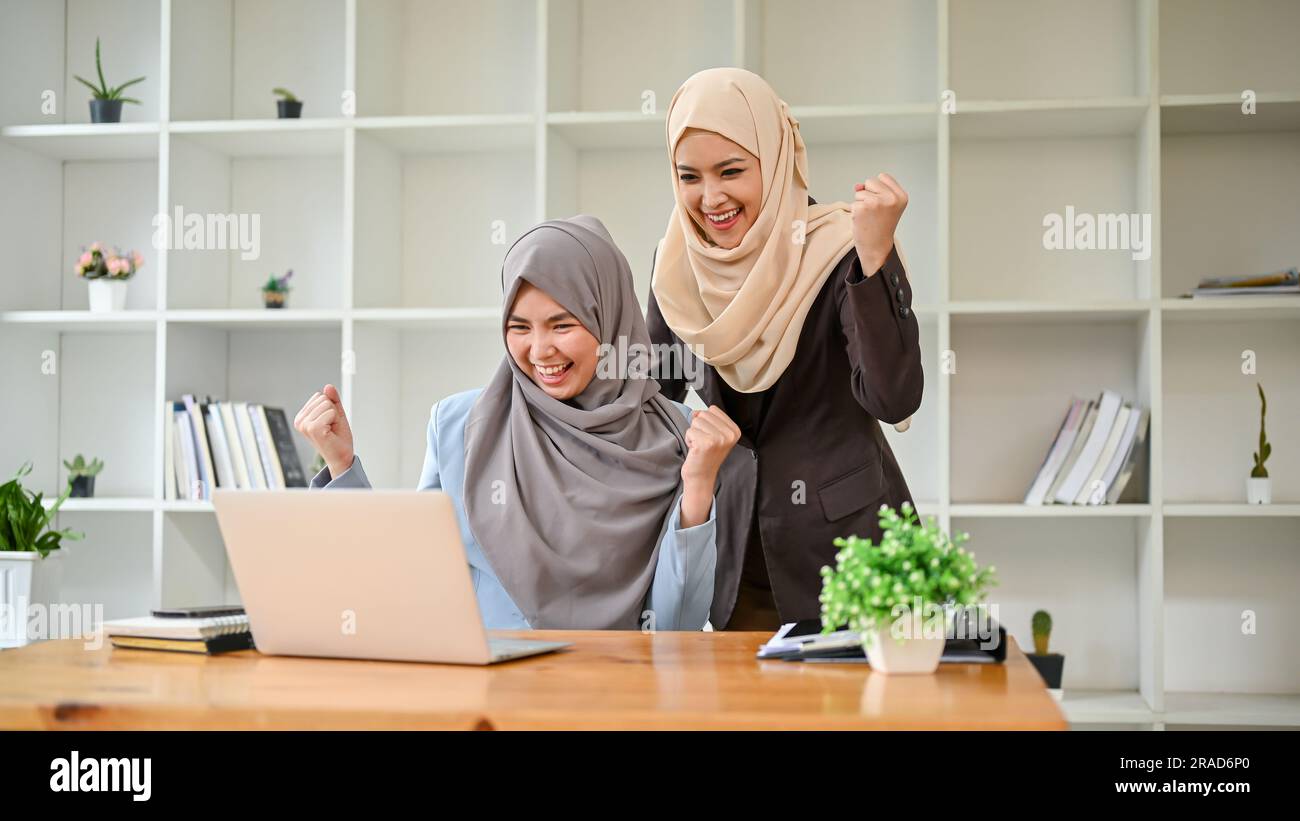 Happy and successful team of Muslim business people celebrating ...