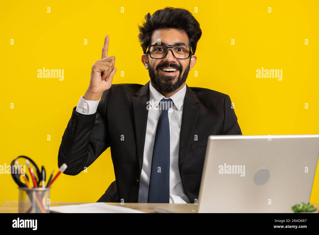 Eureka. Inspired indian businessman pointing finger up, having good ...