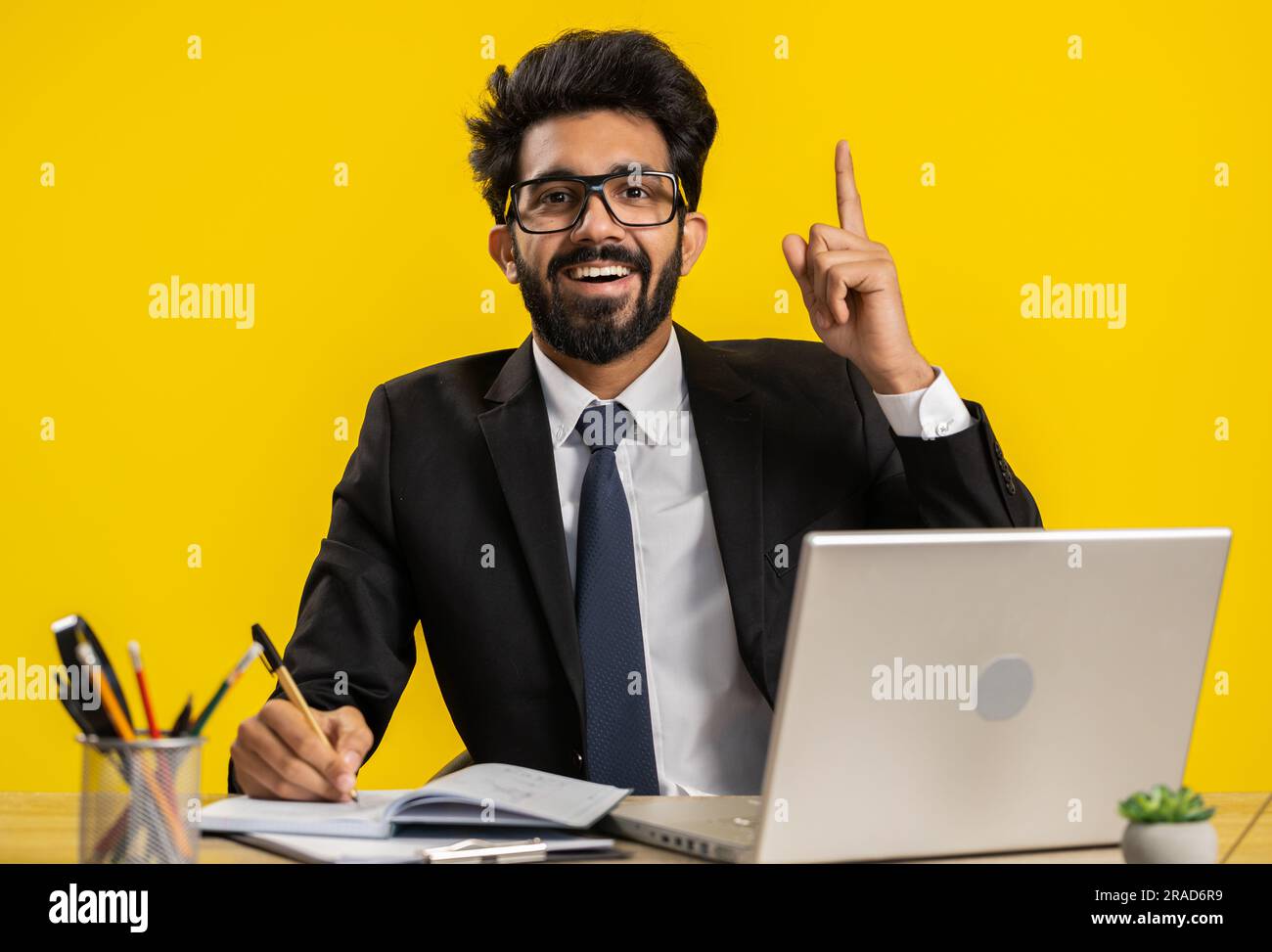 Thoughtful journalist indian businessman making notes, writing down ...