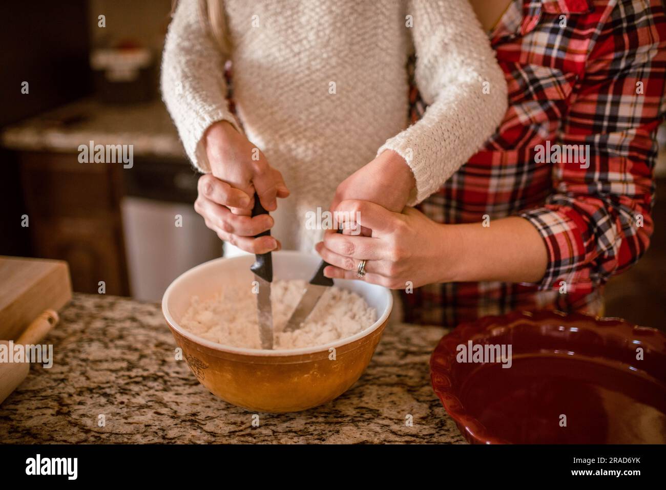 Mom and daughter preparing pie in kitchen Stock Photo - Alamy