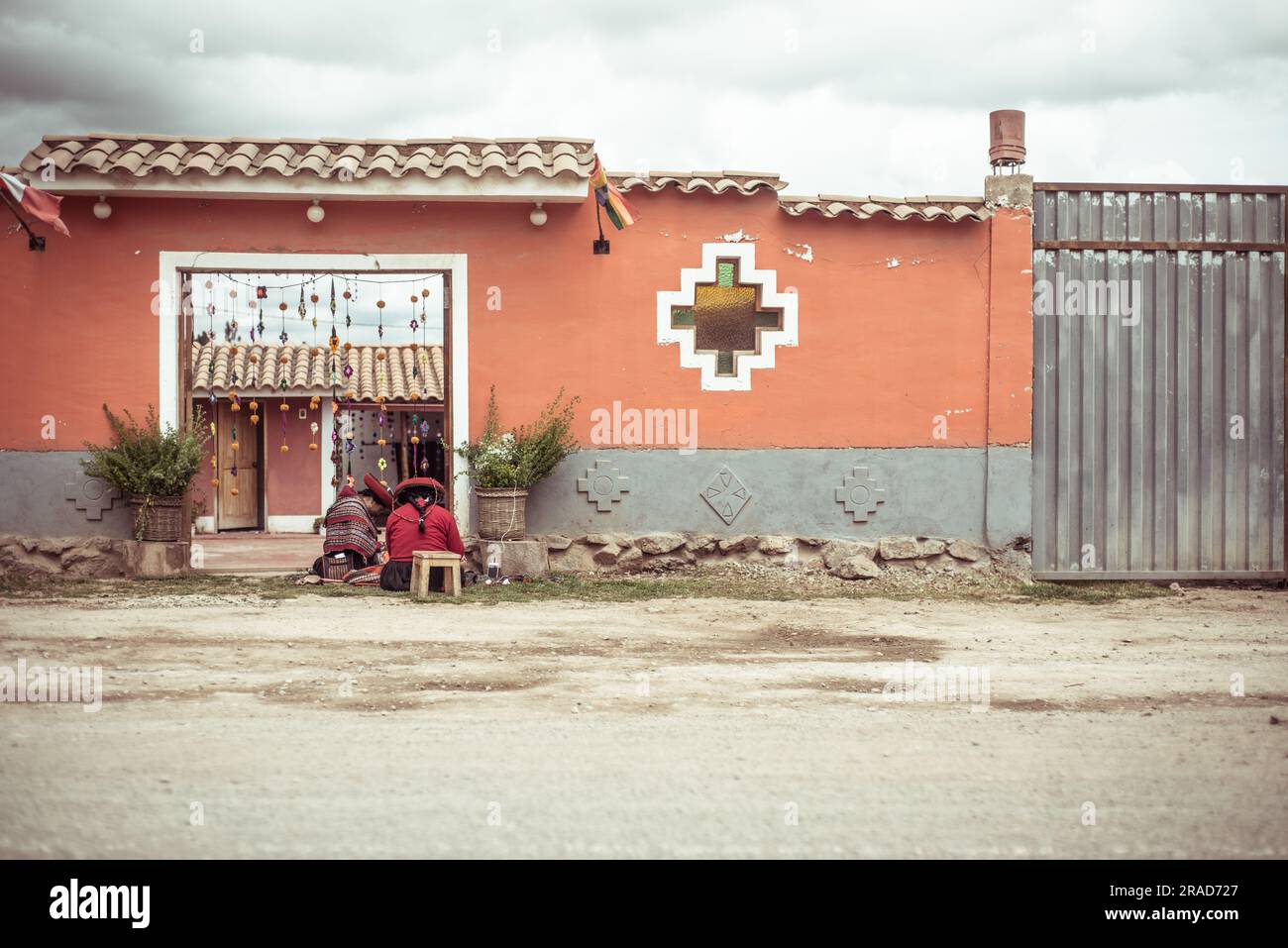 local weavers sit working on road side outside small craft market Stock ...