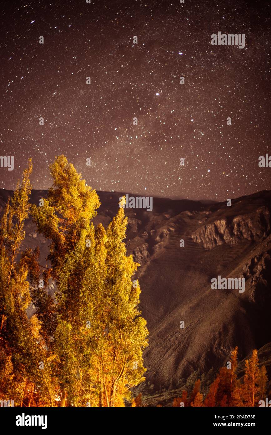 Stars shine bright above beautiful remote mountain range in peru Stock ...