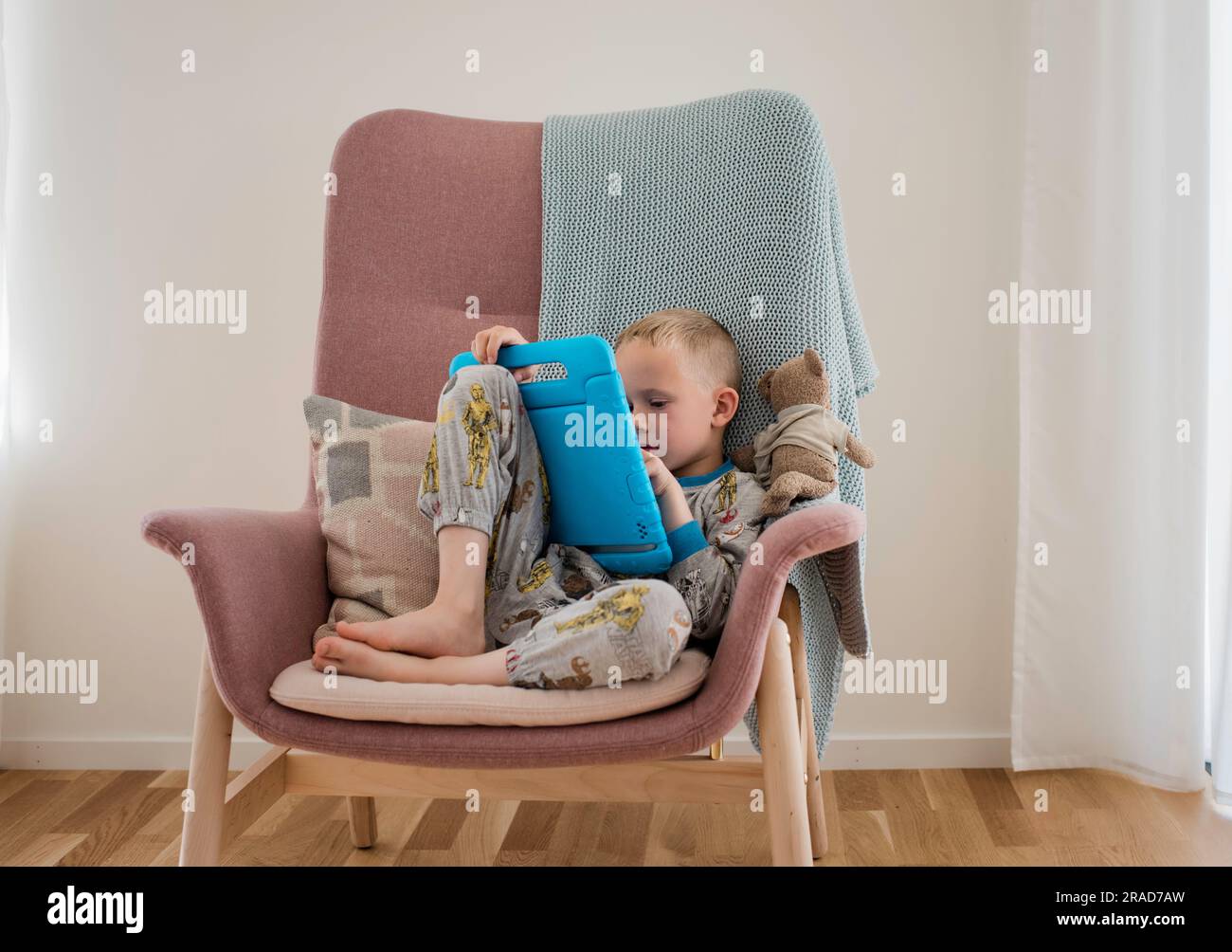 young boy playing on his iPad at home Stock Photo - Alamy