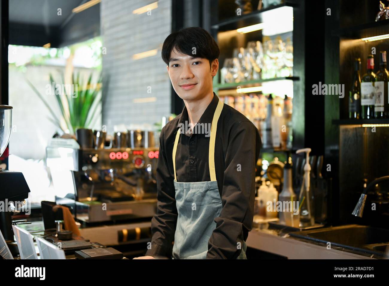 Asian male barista standing hi-res stock photography and images - Alamy