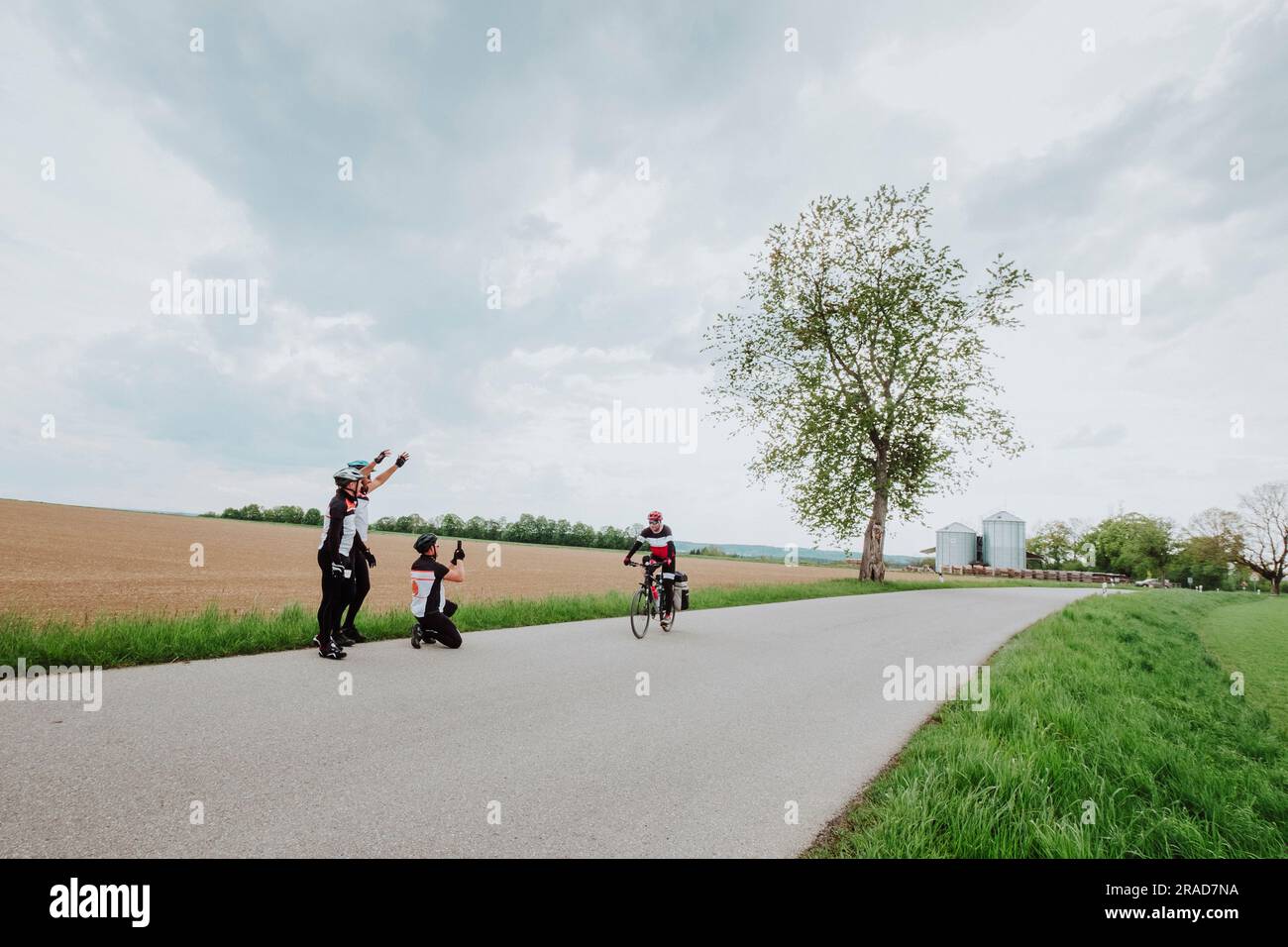 Cyclists waiting for a friend in the middle of the route Stock Photo ...