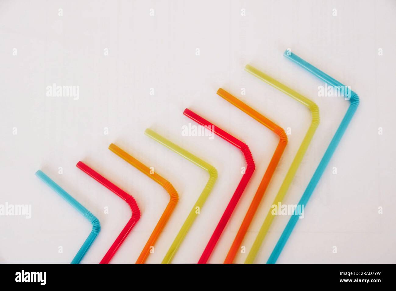 White background with colored straws Stock Photo - Alamy