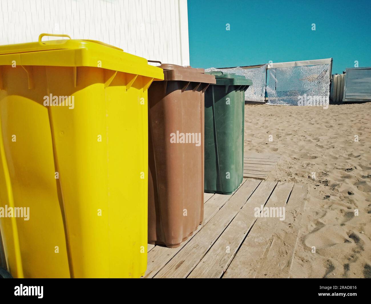 Recycling containers on the beach Stock Photo - Alamy