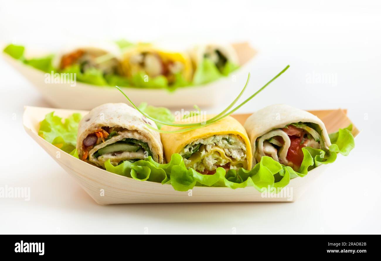 Assortment of fresh tortilla wraps with chicken, cheese and vegetables ...