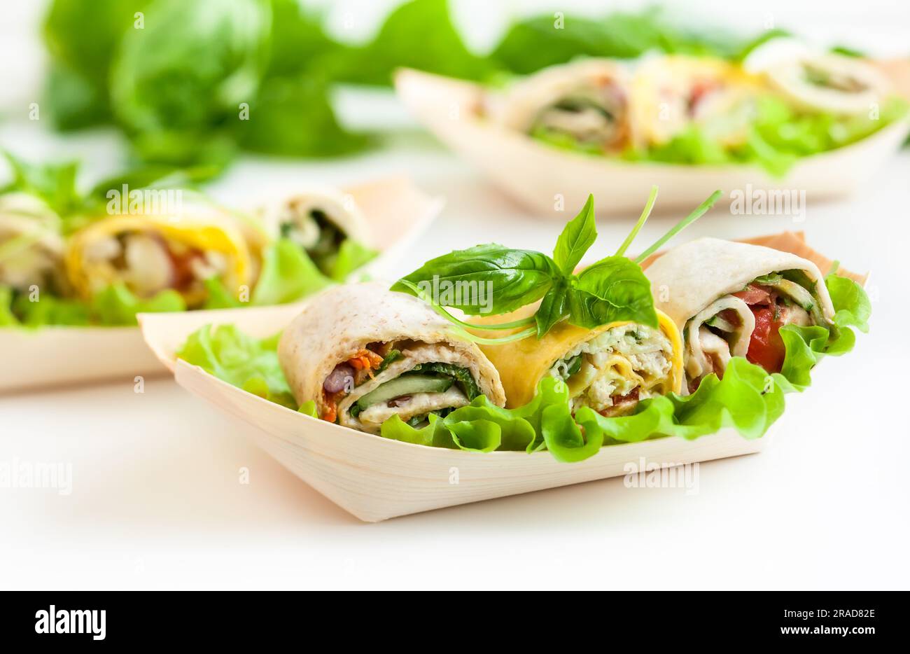Assortment of fresh tortilla wraps with chicken, cheese and vegetables ...