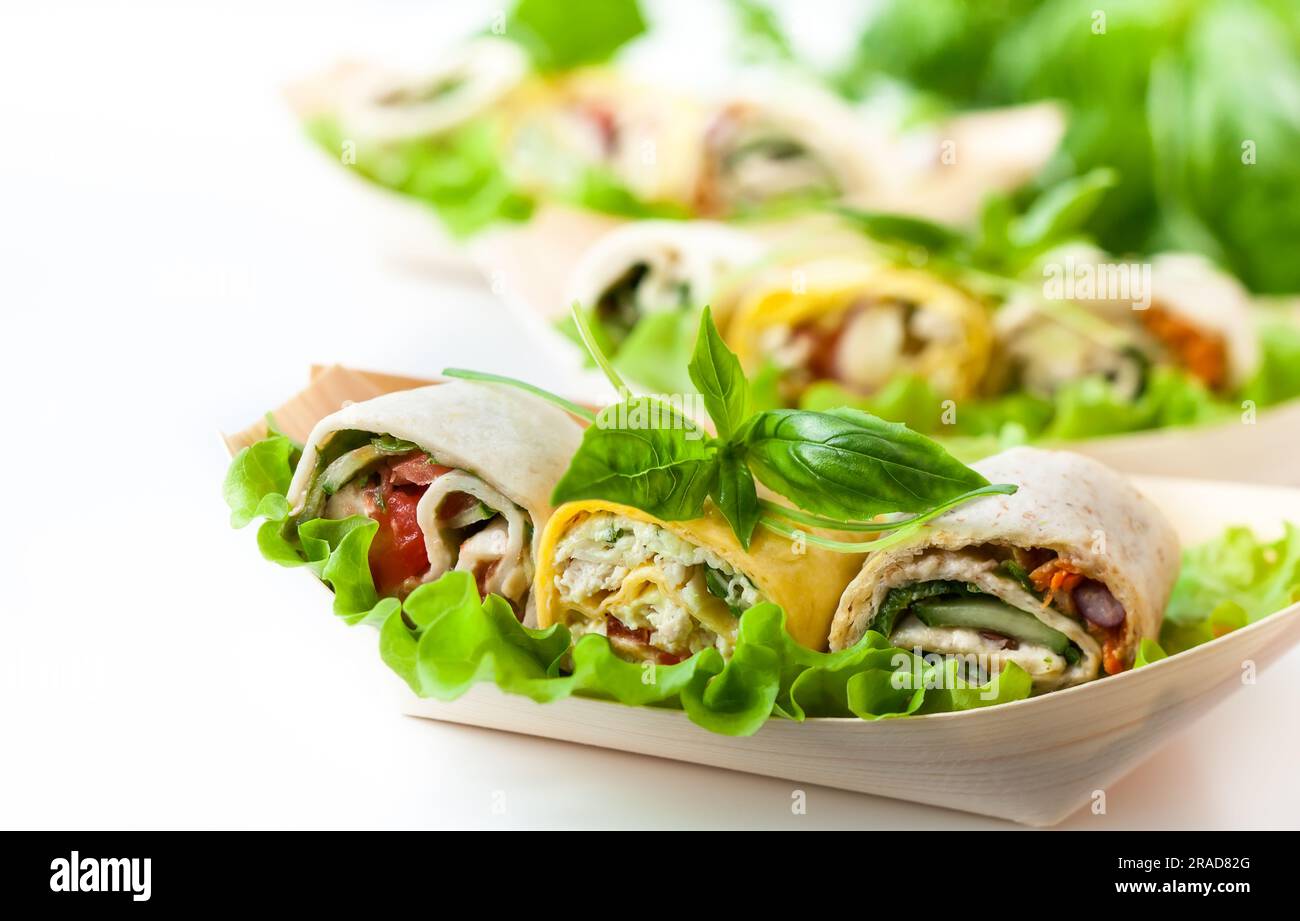 Assortment of fresh tortilla wraps with chicken, cheese and vegetables ...
