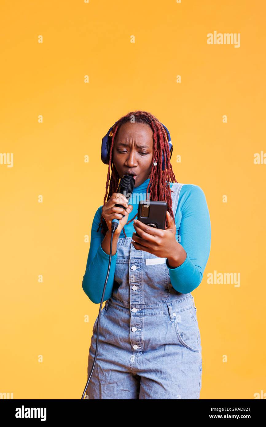 Woman creating sound performance live with microphone in studio ...