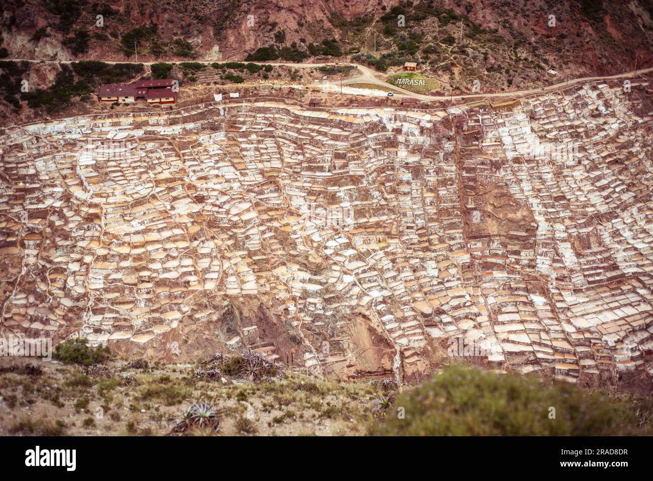 Wide birds eye shot of huge salt farms on side of mountains Stock Photo ...