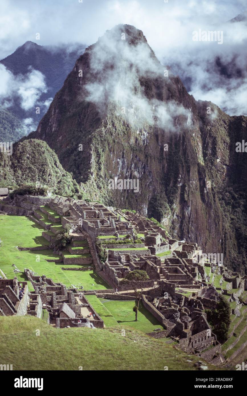 Epic view of mountains in clouds behind Machu Picchu inca city ruins ...