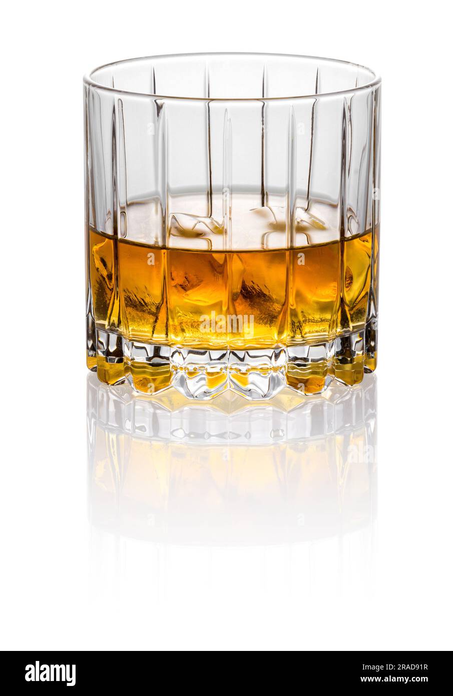 Cold whiskey in transparent glass with ice cubes isolated on white ...