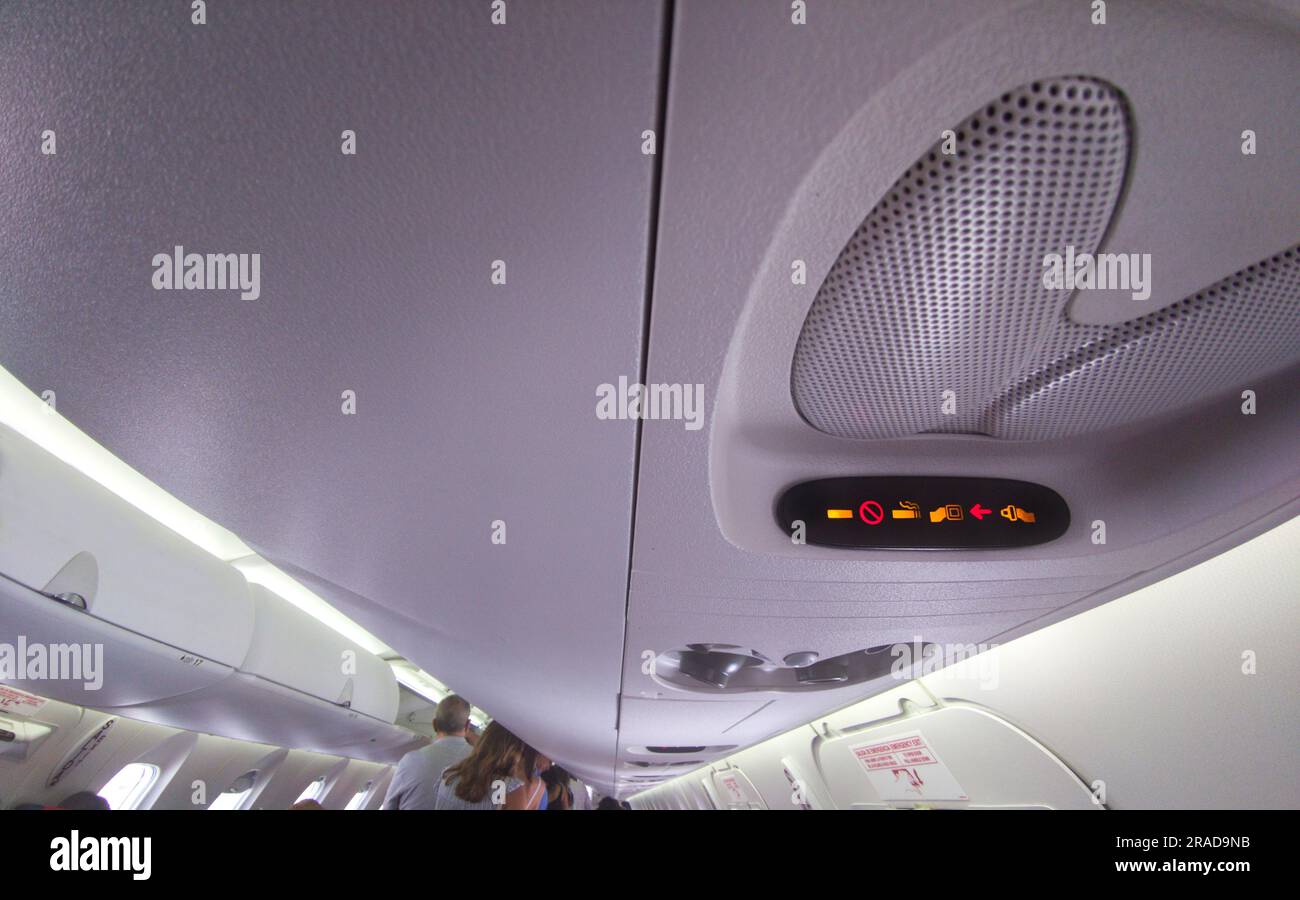 Non smoking and belt sign in aircraft cabin ceiling. Passenger jet ...