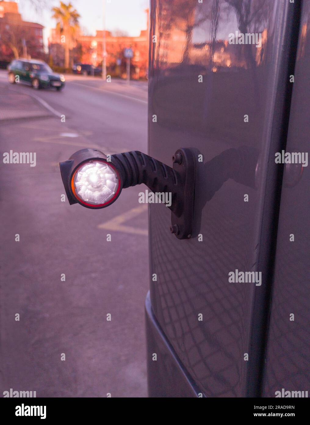 Rear side marker light attached on bus. Urban sunset background Stock ...