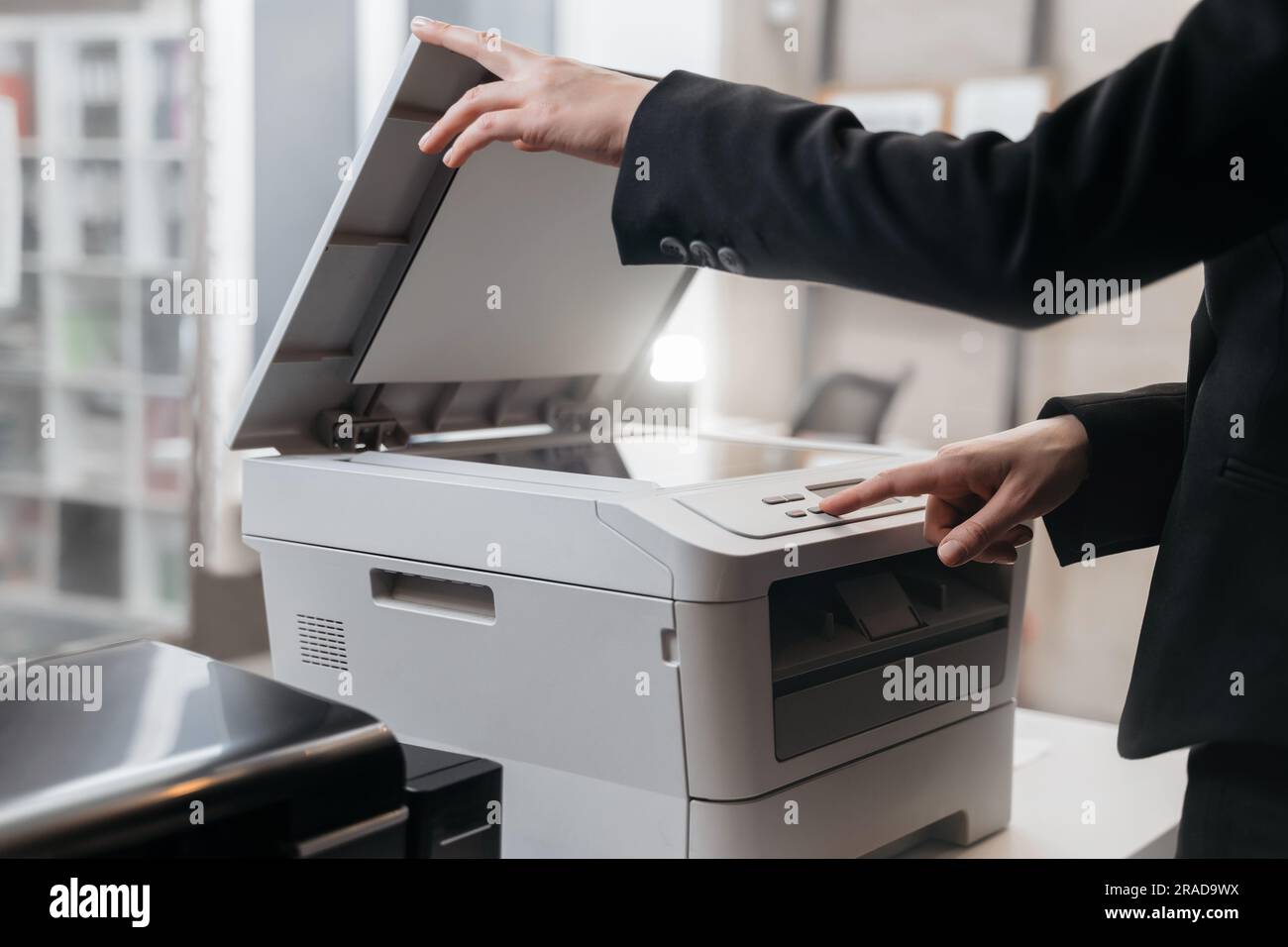 Business woman is using the printer to scanning and printing document ...