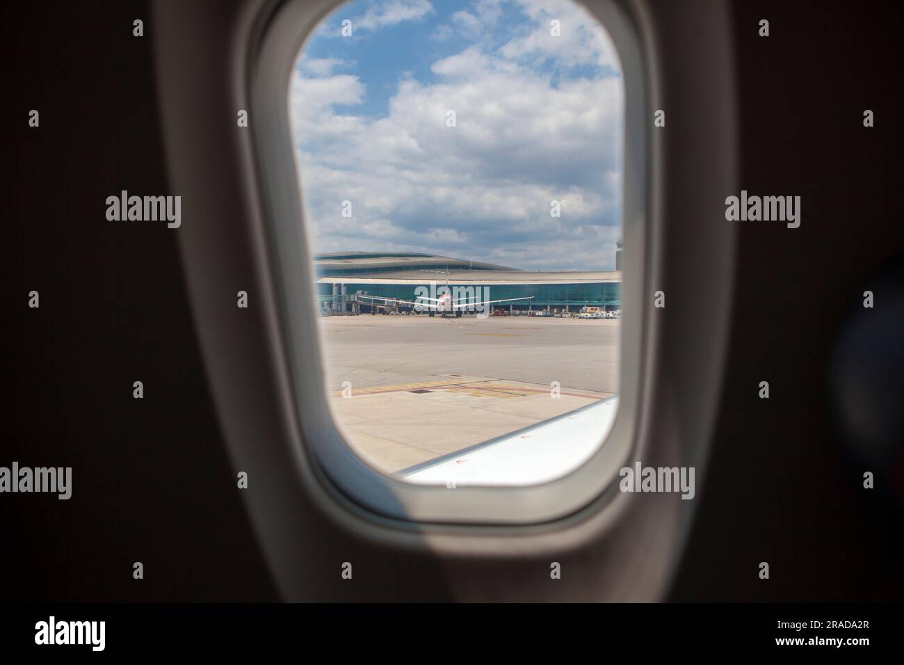 Boarding terminal seen from aircarft window. Blue cloudy sky Stock ...