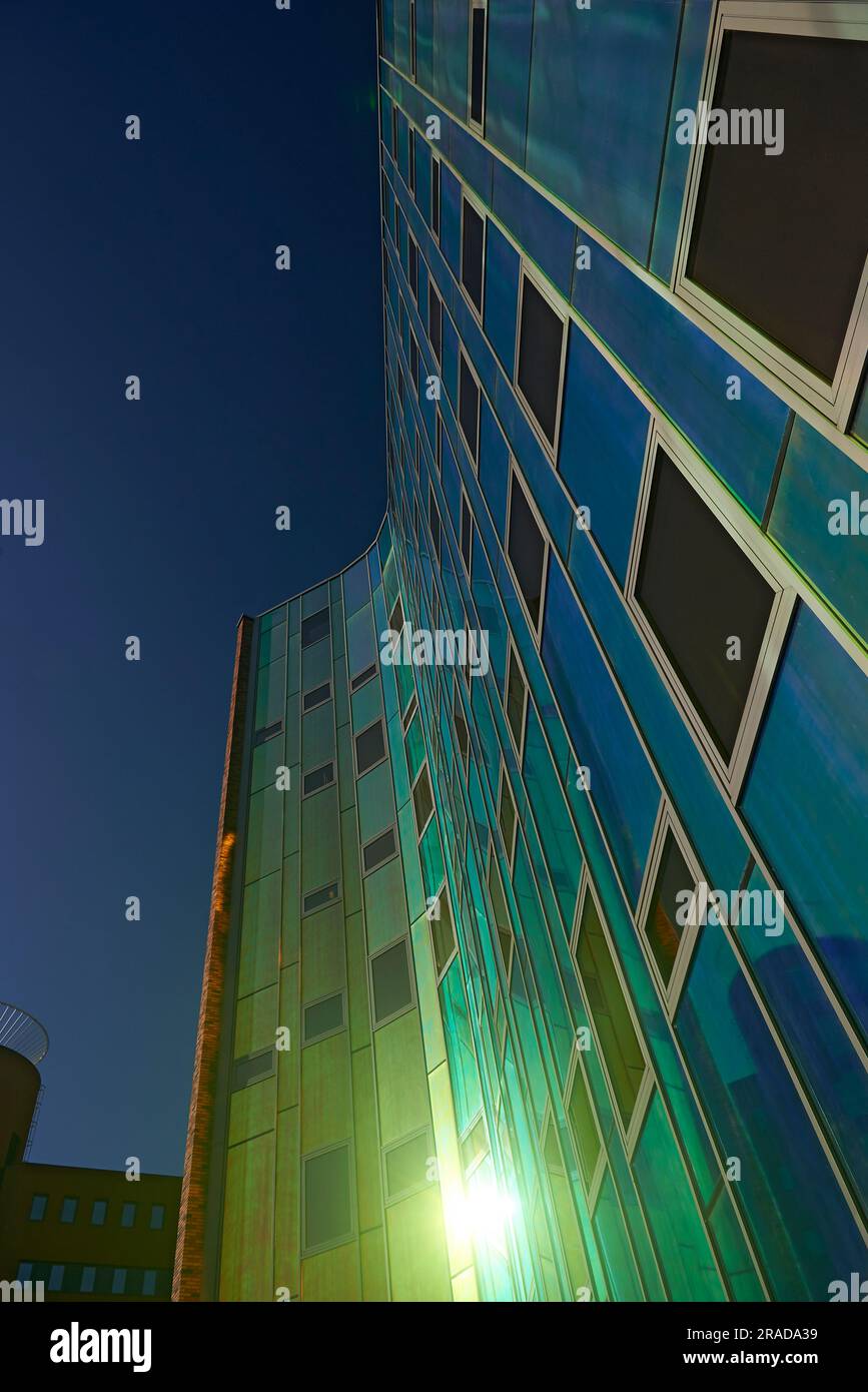 Amazing colourful reflective facade of a modern office building in sun ...