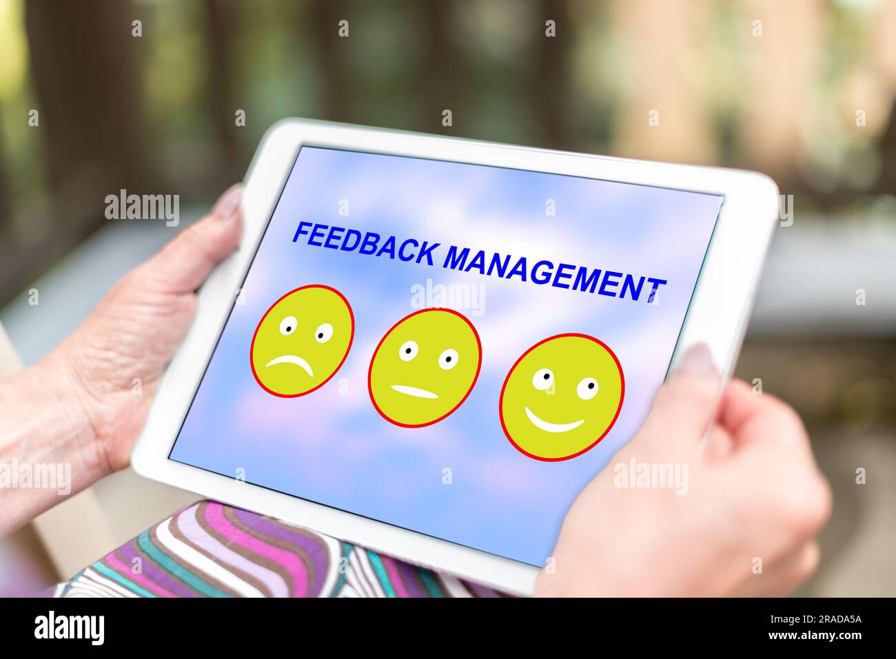 Female hands holding a tablet with feedback management concept Stock ...