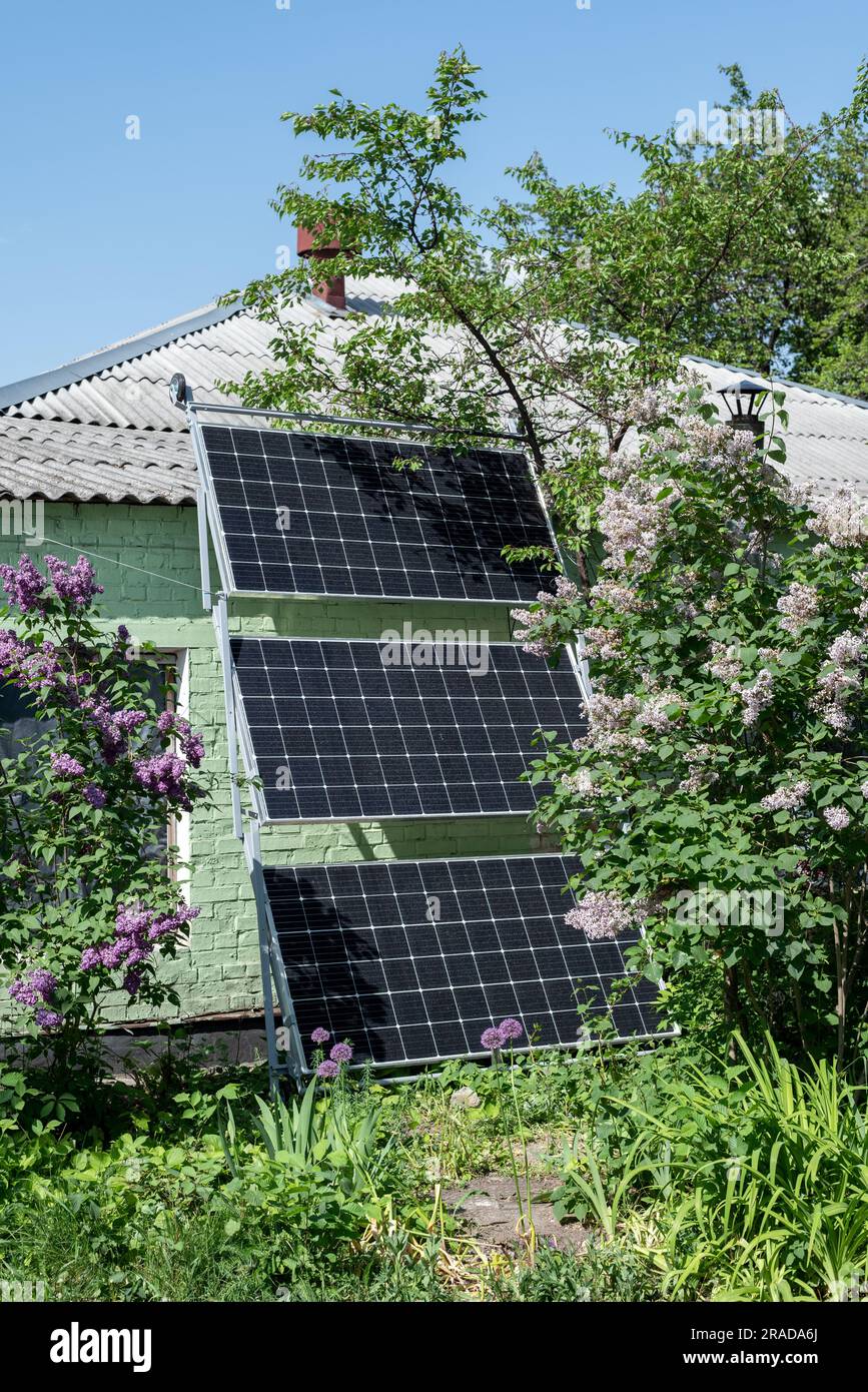 Old house with a solar panel in nature. Photovoltaic panels on the roof ...