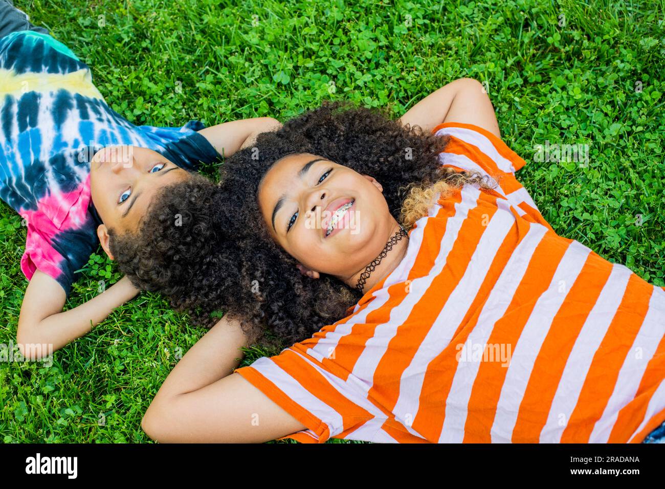 Siblings goofing around in backyard Stock Photo - Alamy