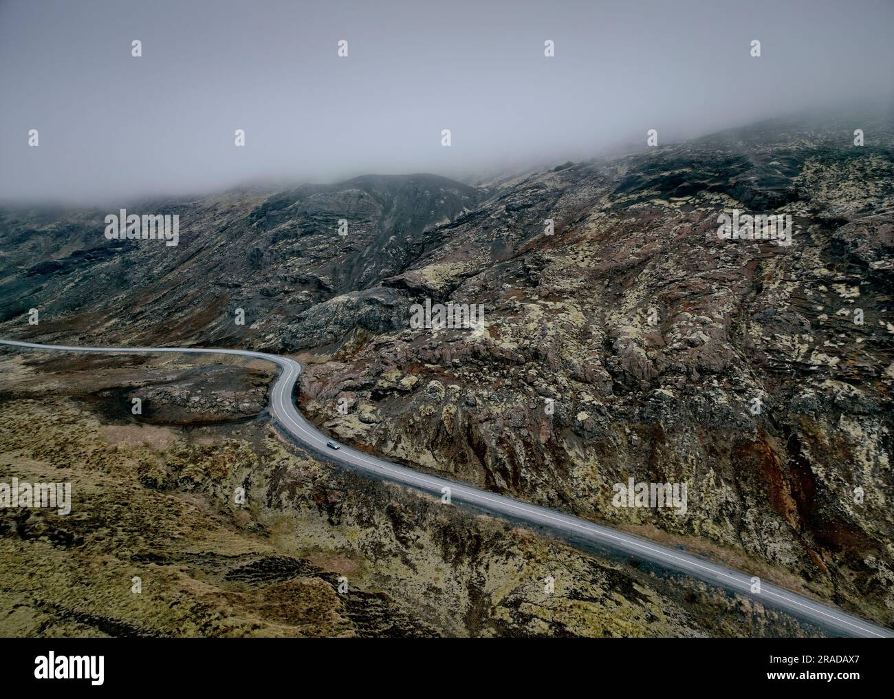 Asphalt road in mountainous terrain in fog Stock Photo - Alamy