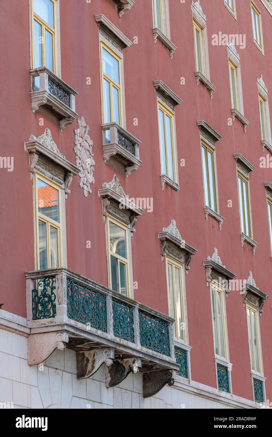 rows of windows on pink painted historic building in grad split croatia ...