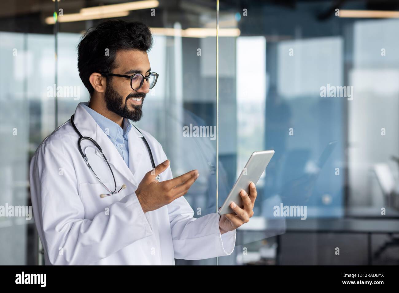 Successful professional Indian doctor working inside modern clinic, man ...