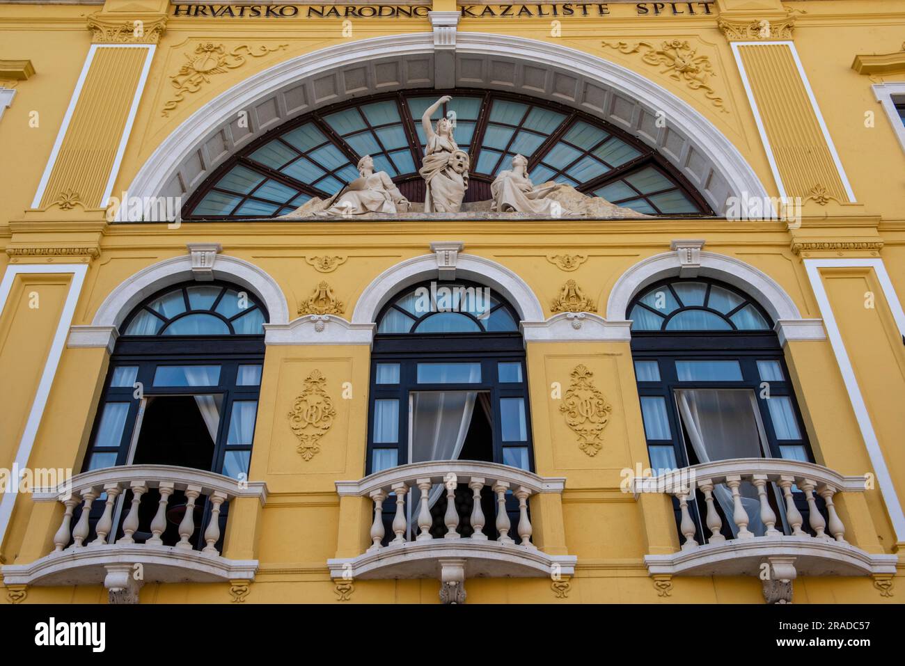 arched windows on bright yellow painted national theatre in grad split ...