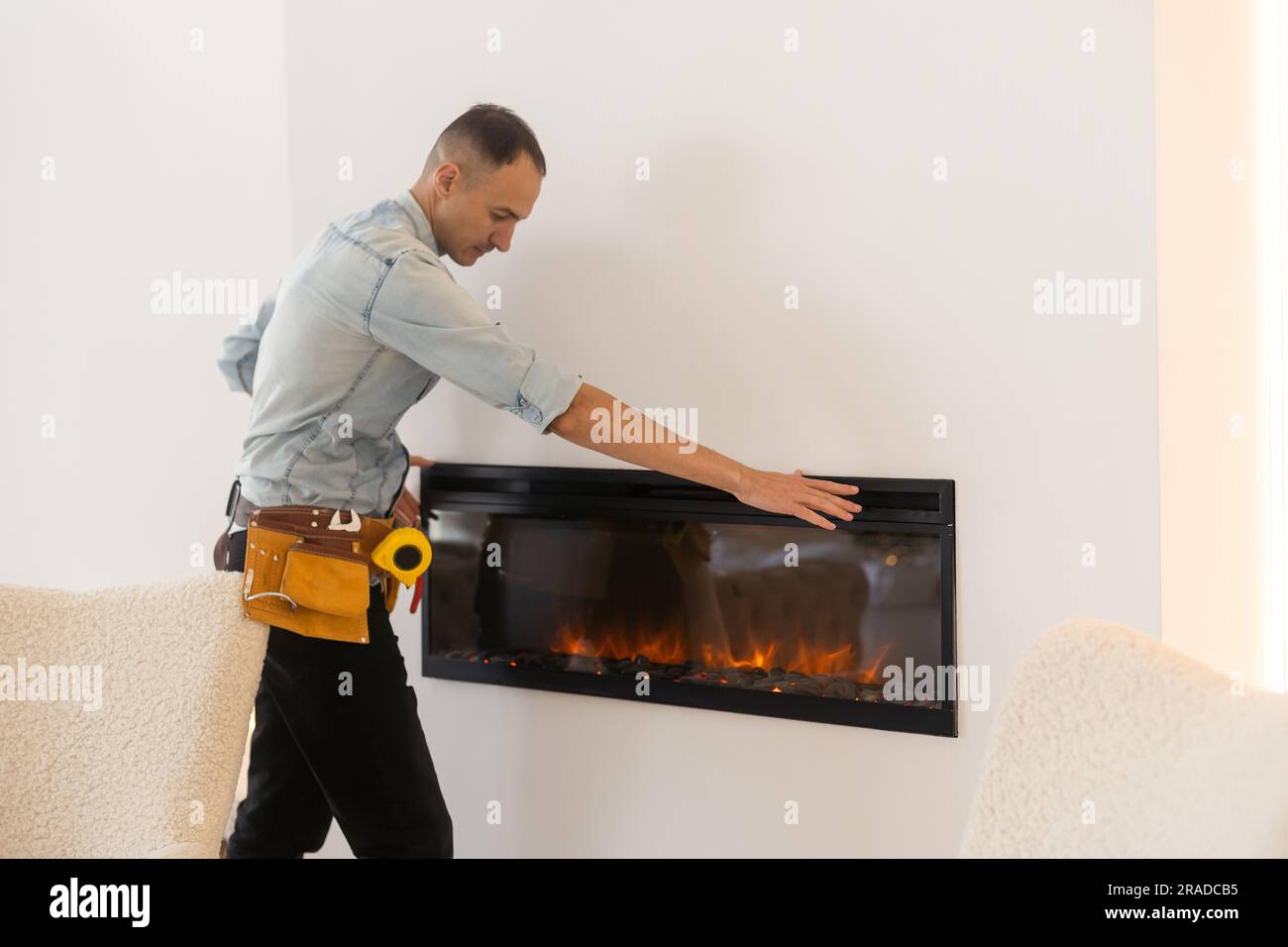 fireplace worker, installation and repair Stock Photo - Alamy