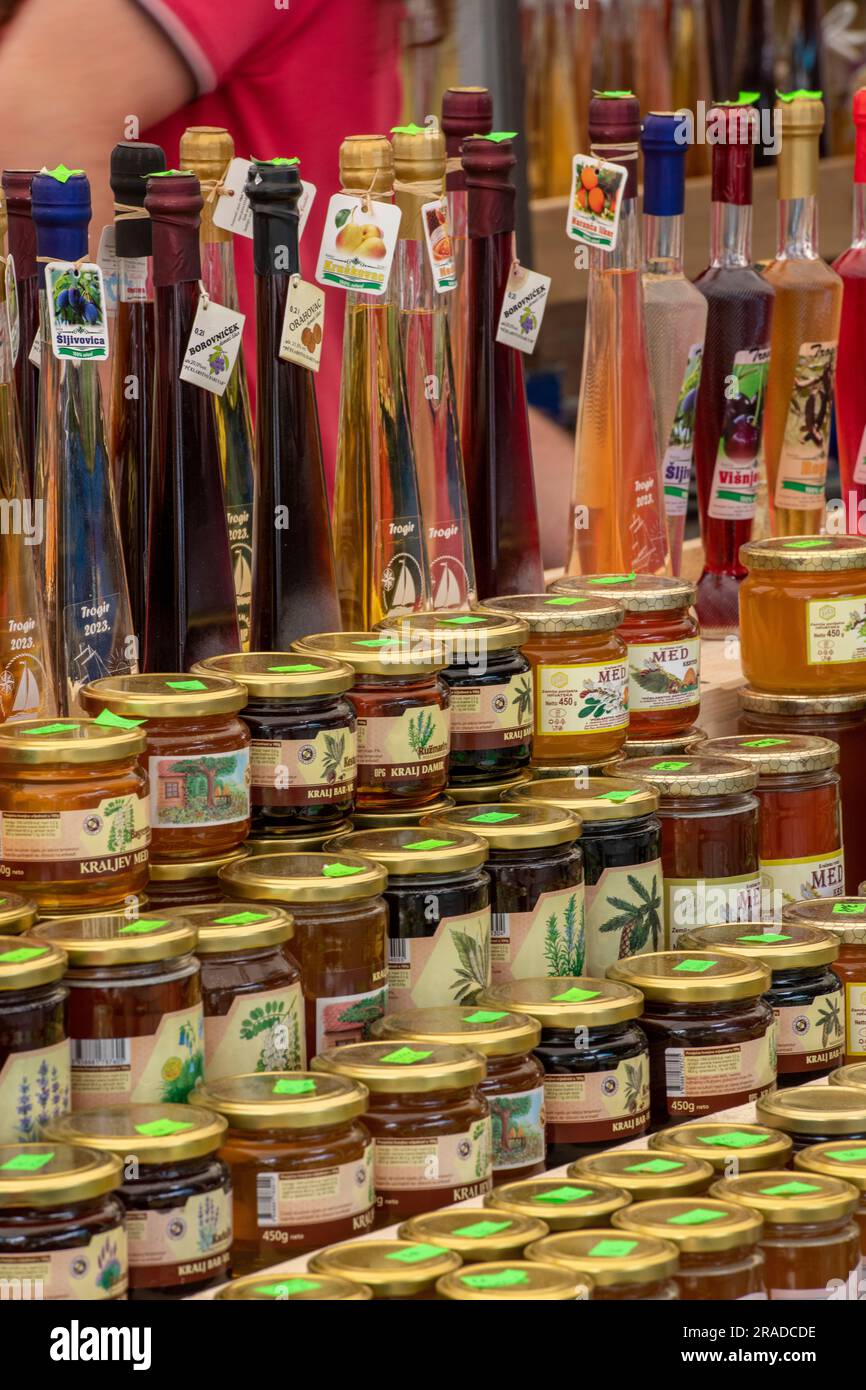 bottles of olive oil and variety of jams and preserves on display at ...
