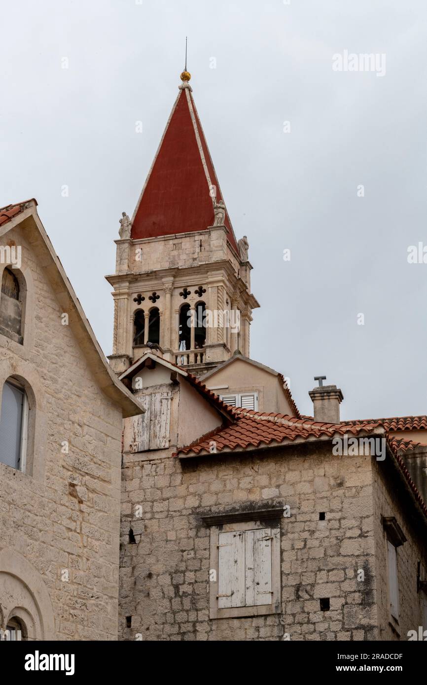 historic old town and stone buildings with church steeple in trogir ...