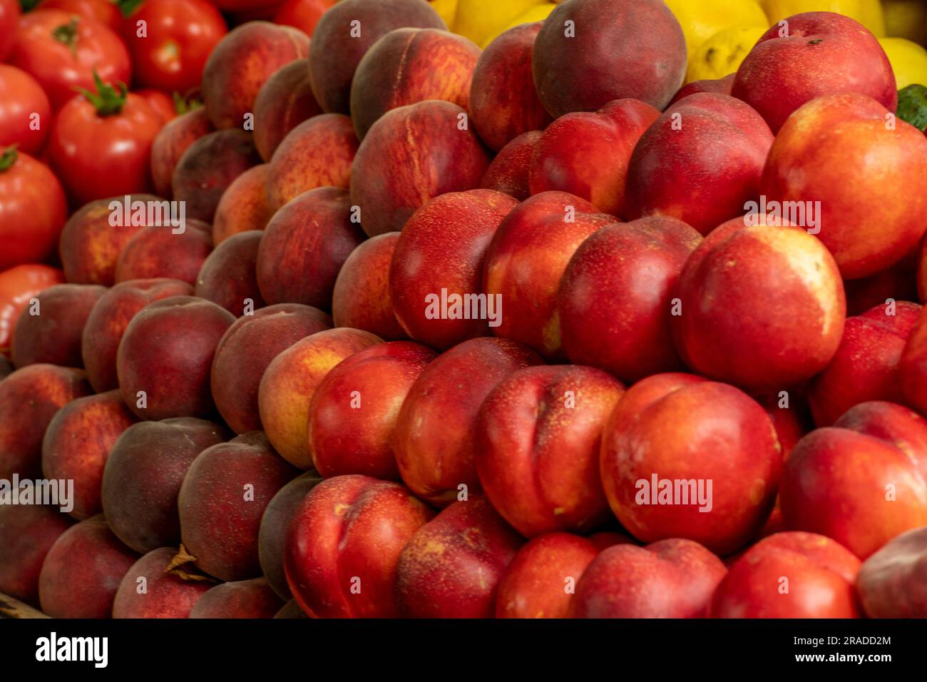 fresh juicy peaches on display on a market stall, fresh fruits and ...