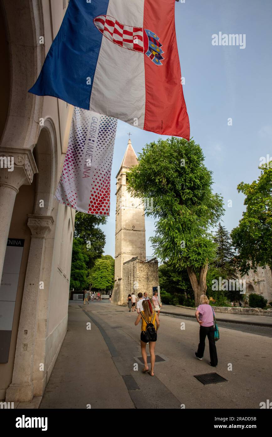 tourists walking through the old town in grad split croatia, church ...