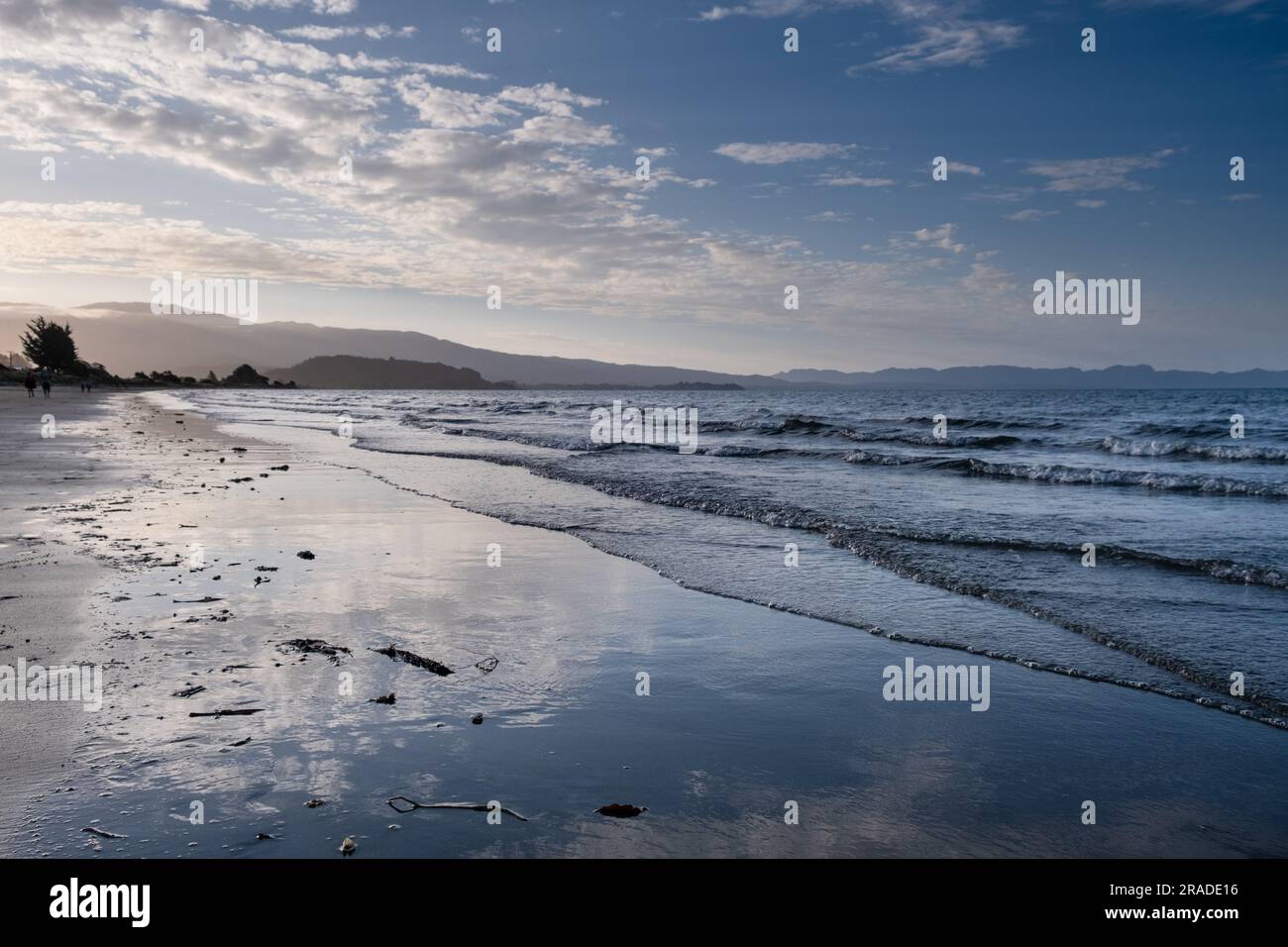 A beautiful summer evening on Pōhara Beach in the Takaka Coastal Region ...