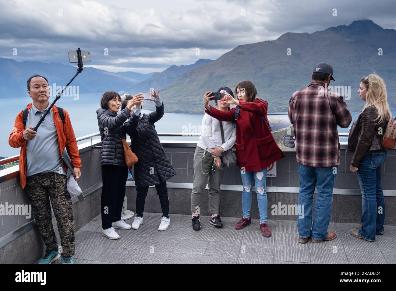 Asian tourists take mobile phone pictures at the Skyline Resort on Bob ...