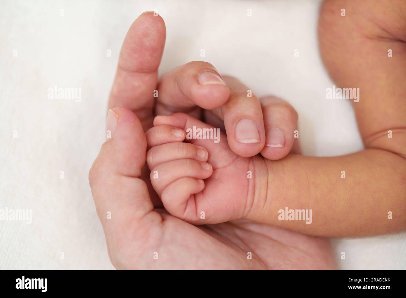 mother holding newborn baby hand on a bed Stock Photo - Alamy