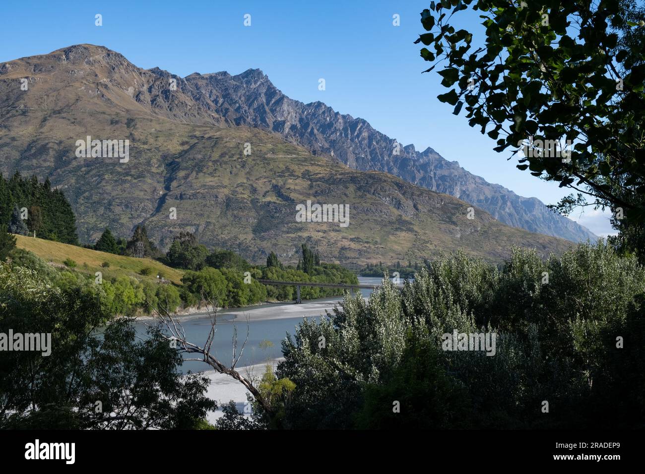 The iconic Remarkables Mountains viewed above the popular cycle path ...