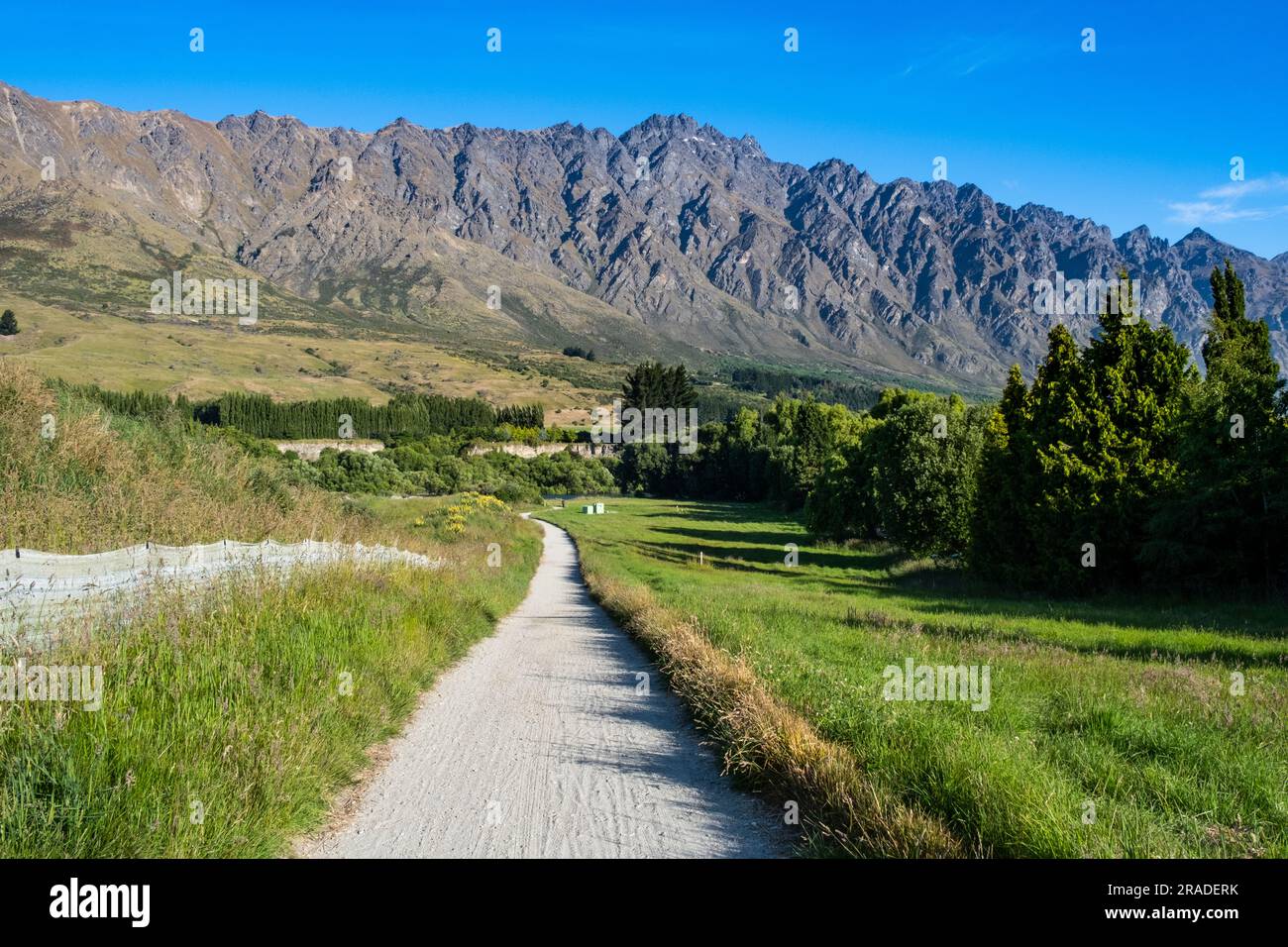 The iconic Remarkables Mountains viewed above the popular cycle path ...