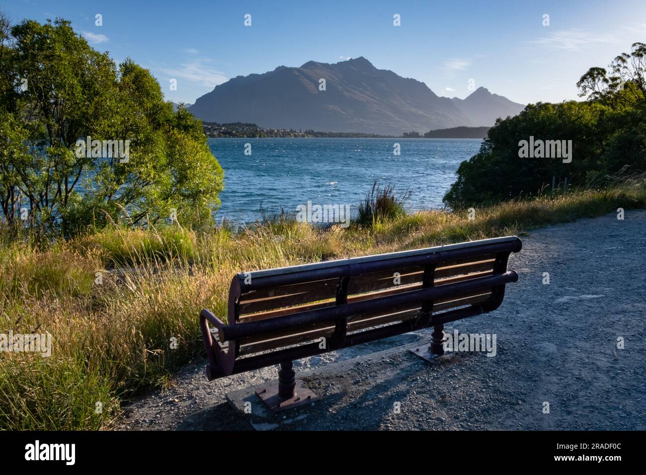 A quiet bench seat overlooking Lake Wakatipu and Cecil Peak on a ...