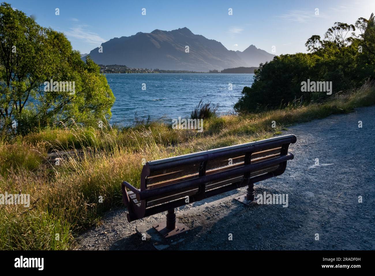 A quiet bench seat overlooking Lake Wakatipu and Cecil Peak on a ...